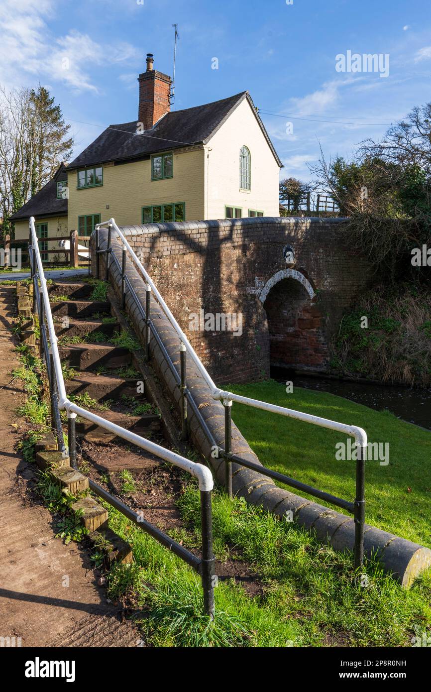 England, West Midlands, Kinver. Stone house and bridge crossing the ...