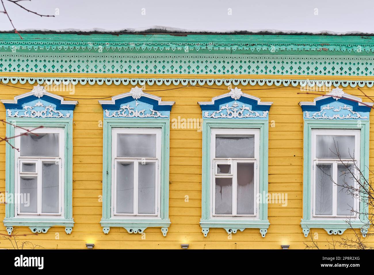 Windows with carved wooden architraves.Platbands with lancet ledge in ...