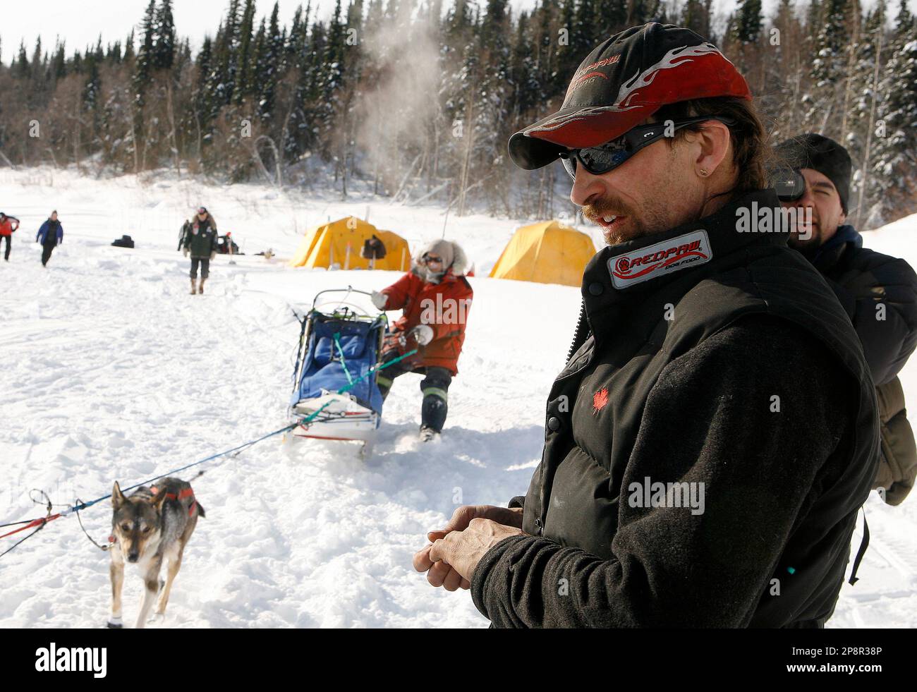Defending Iditarod champion Lance Mackey watches musher Sebastian ...
