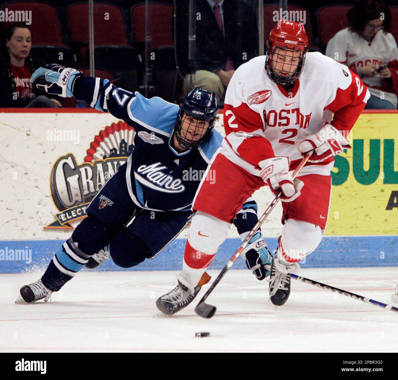 Boston's Eric Gryba (2) heads up ice with the puck pursued by Maine's ...