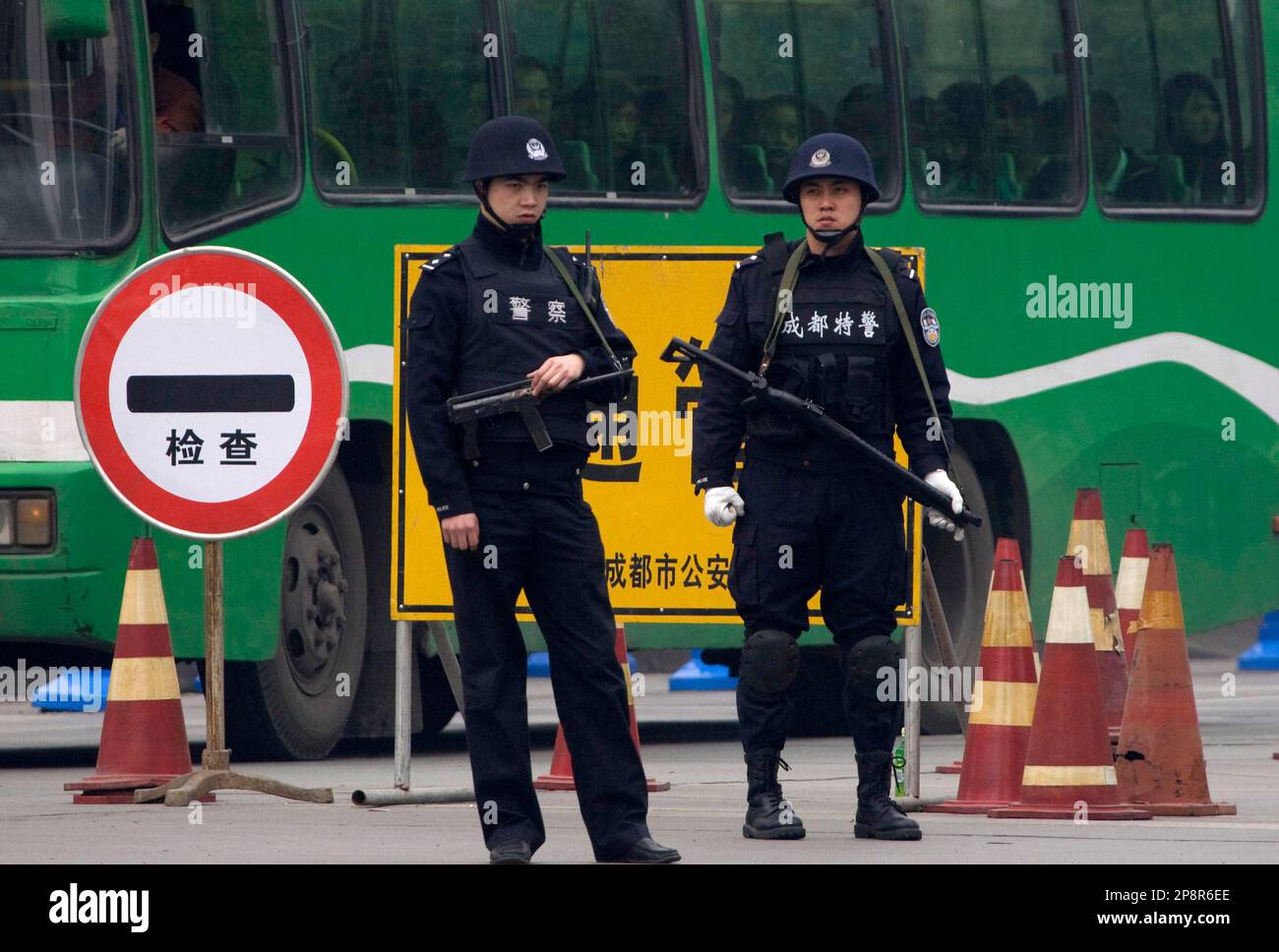 Heavily armed Chinese police officers on duty at a security checkpoint ...