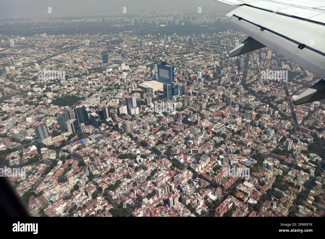 View on Mexico city through airplane window of commercial jet plane ...