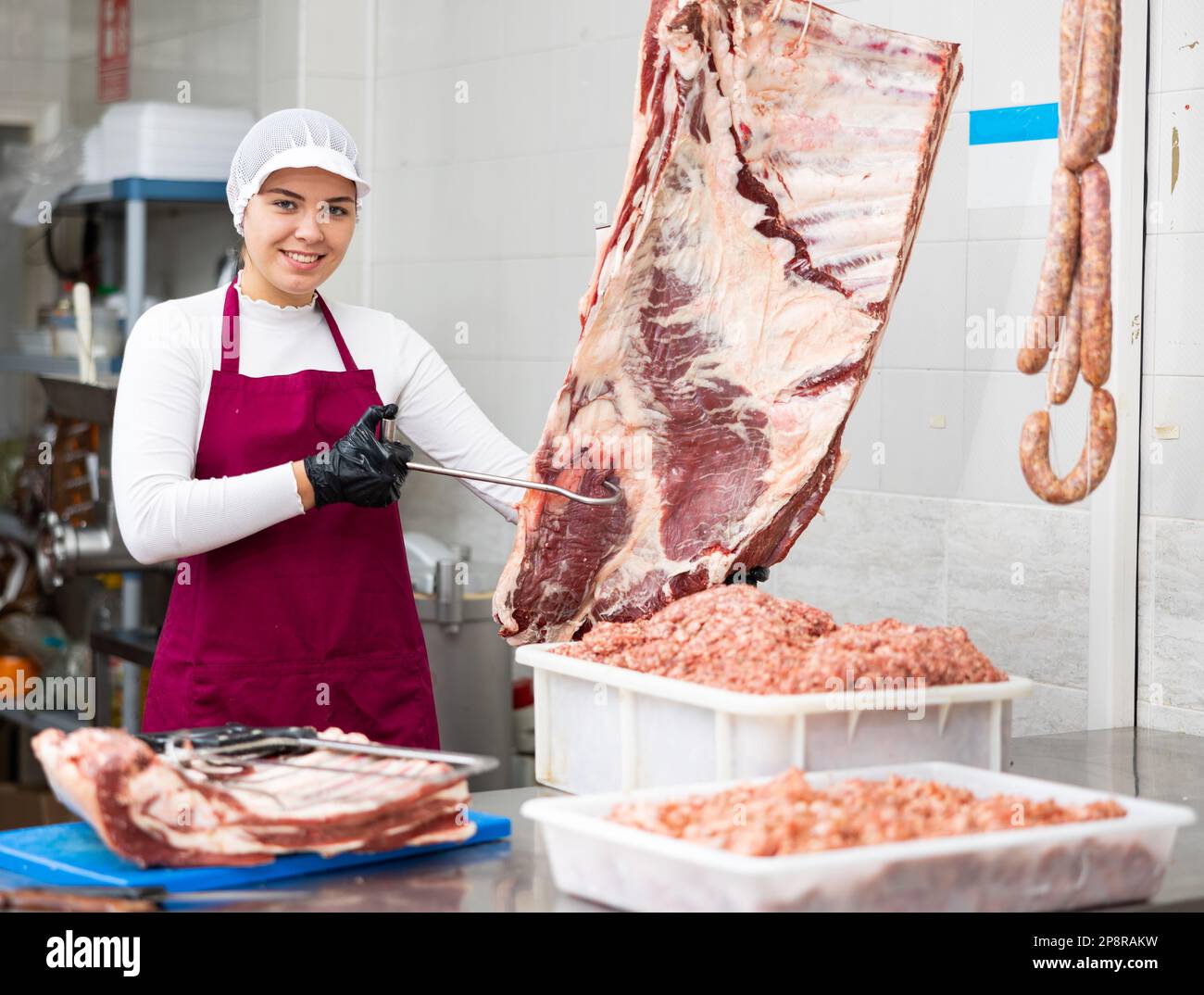 Young butcher holding sausages hi-res stock photography and images - Alamy