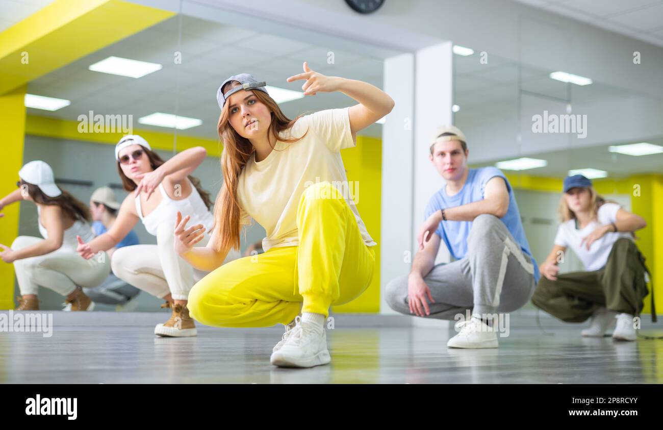 Teen girl in cap dances hip hop dances Stock Photo - Alamy