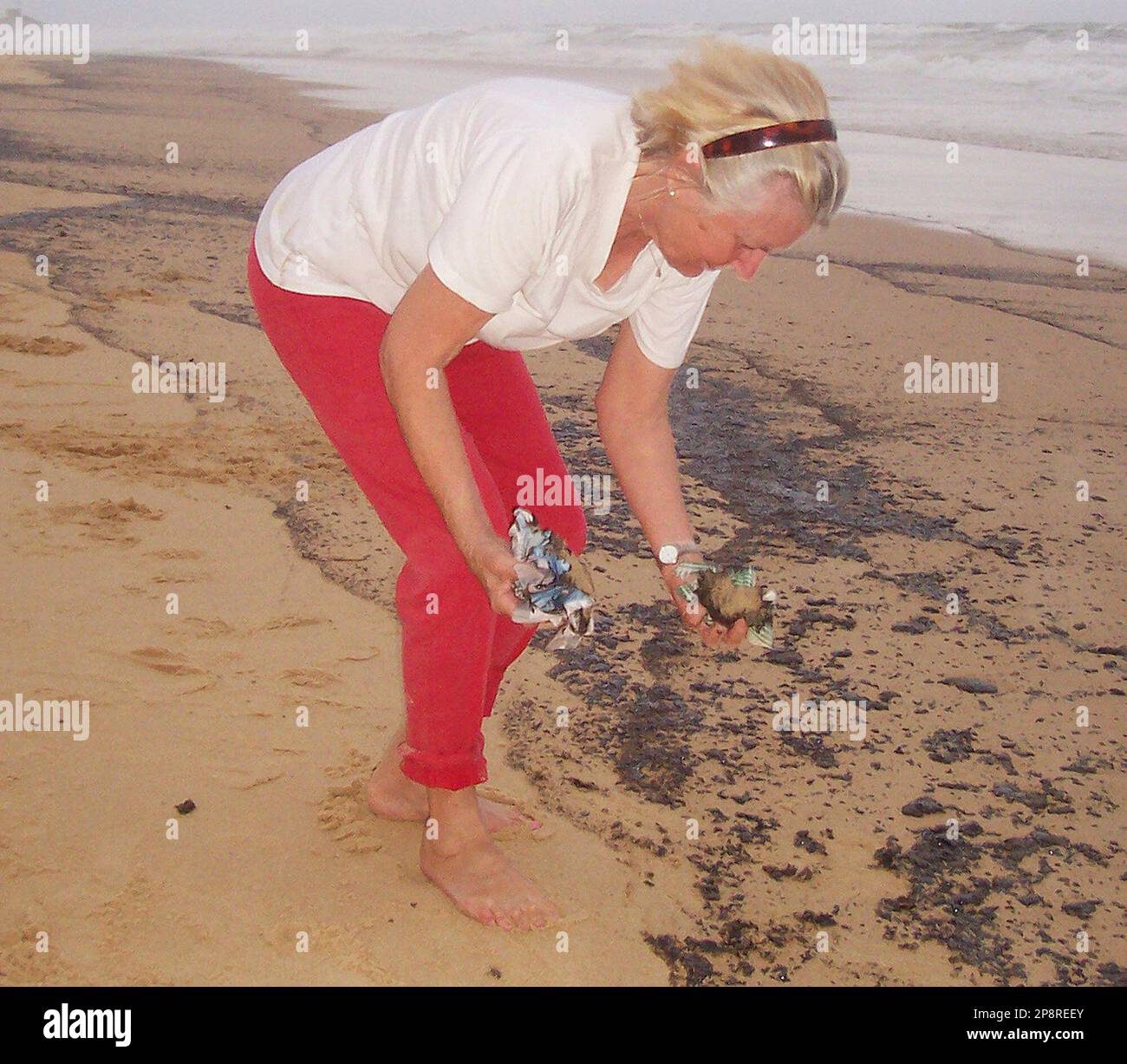 Vicki Ayliffe looks down at the oil stained sand at Buddina Beach on ...