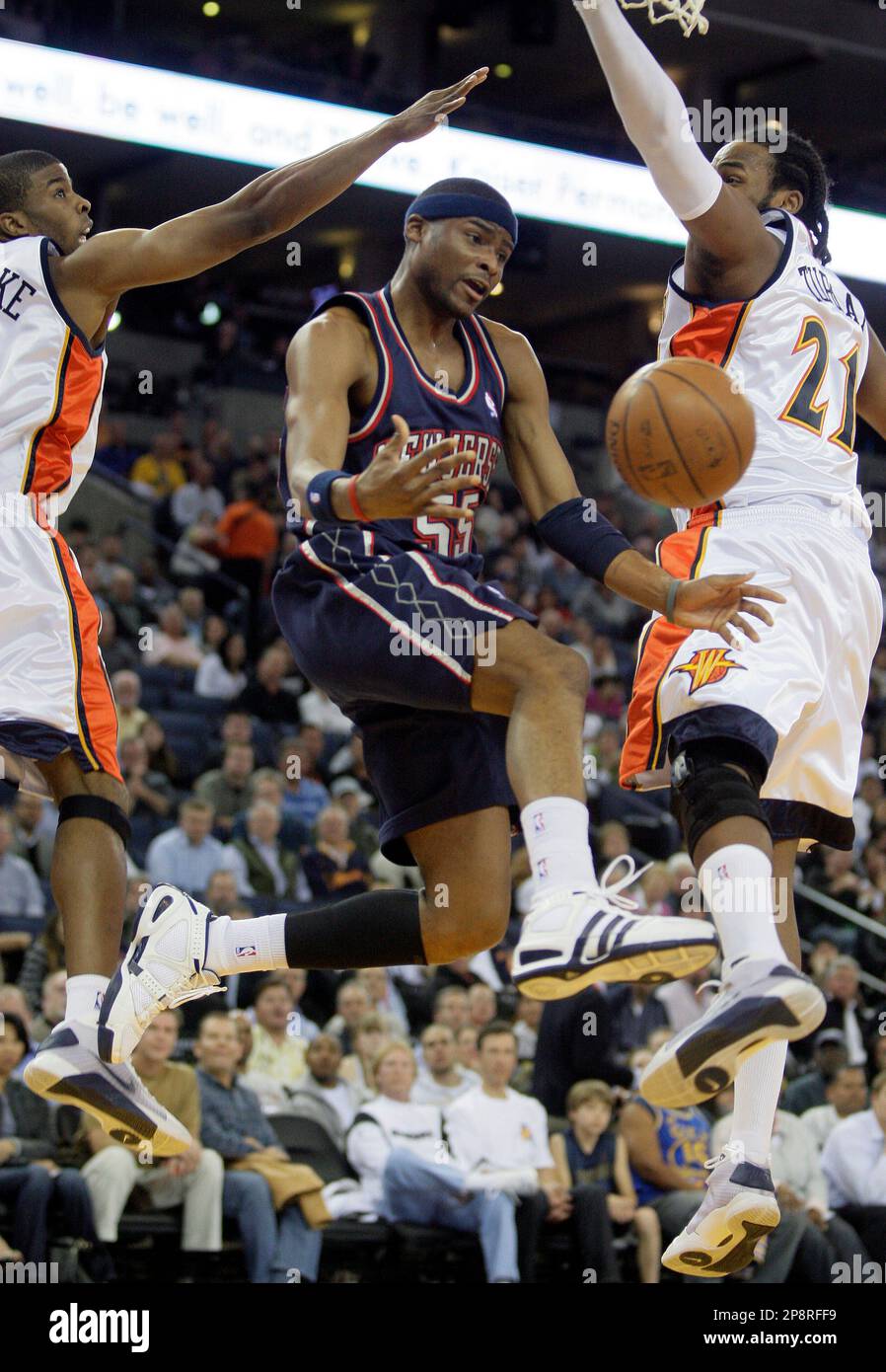 New Jersey Nets' Keyon Dooling (55) passes under the net between Golden ...