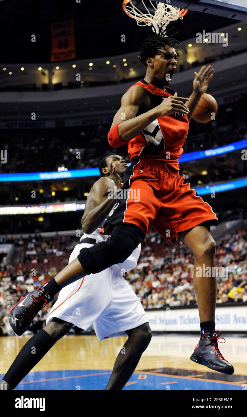 Toronto Raptors' Chris Bosh, right, dunks over Philadelphia 76ers ...