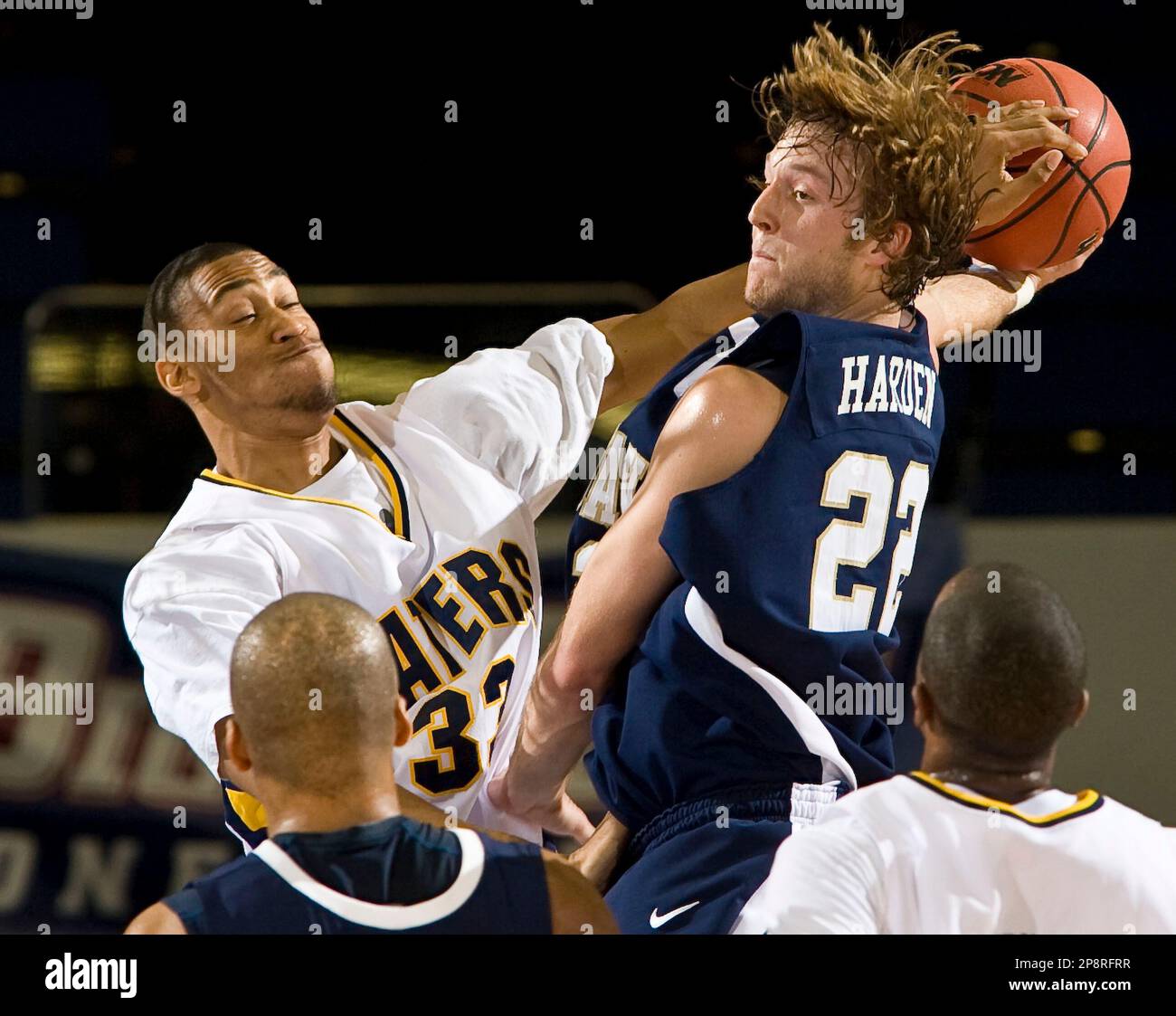 UC Irvine center Zach Atkinson, left, blocks UC Davis guard Joe Harden ...