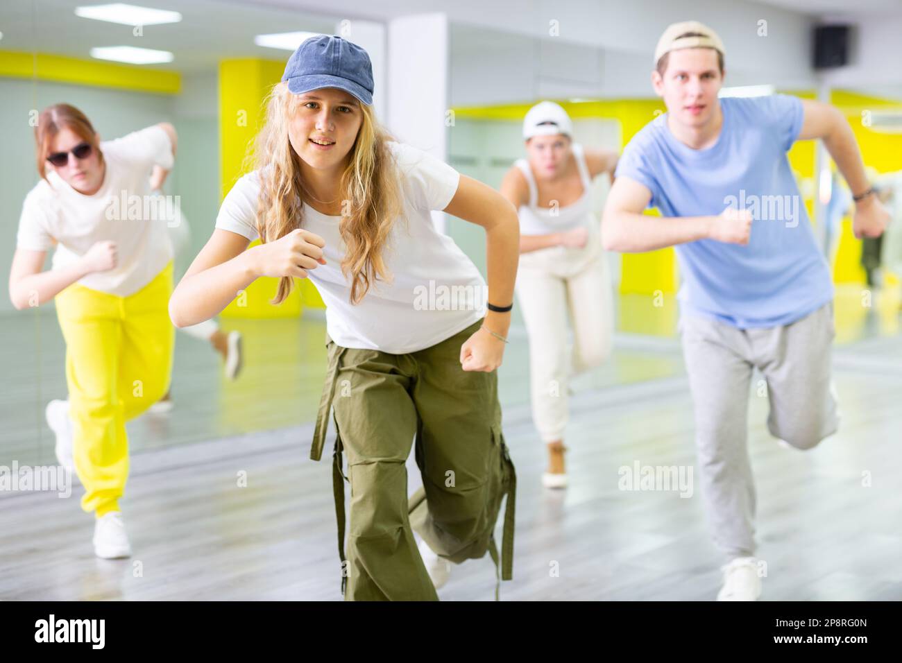 Group of teenagers dancing modern dance in ballroom Stock Photo - Alamy