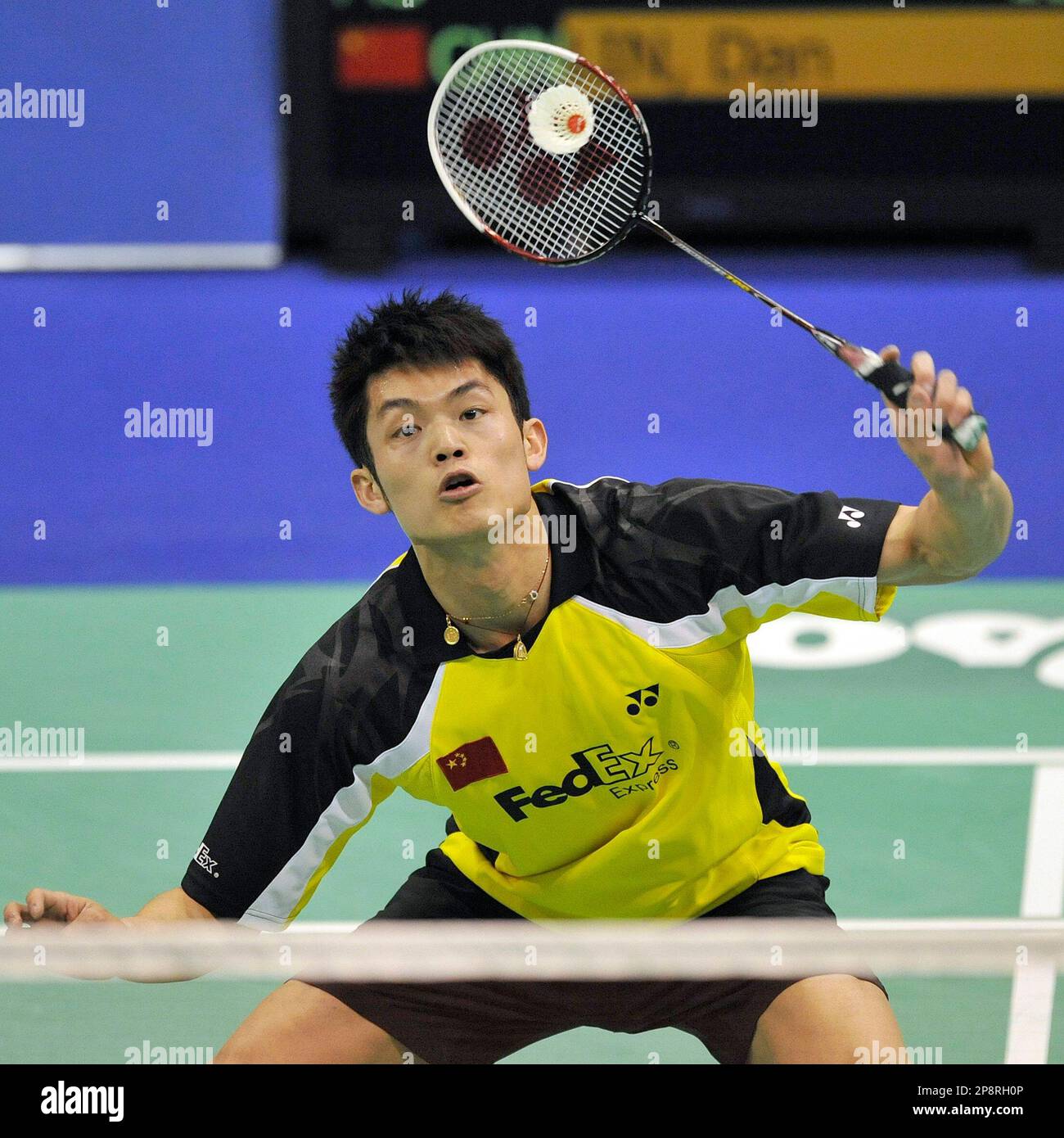 China's Dan Lin returns a shuttlecock to India's Arvind Bhat during ...