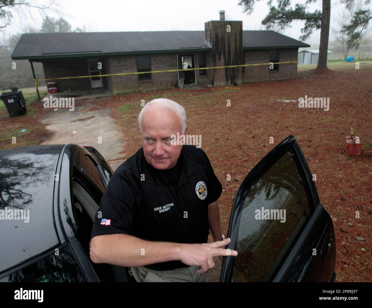 Coffee County Sheriff Dave Sutton stands watch outside a burned out ...