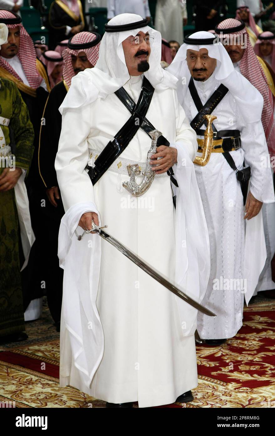 King Abdullah of Saudi Arabia holds his sword as he takes part in the ...