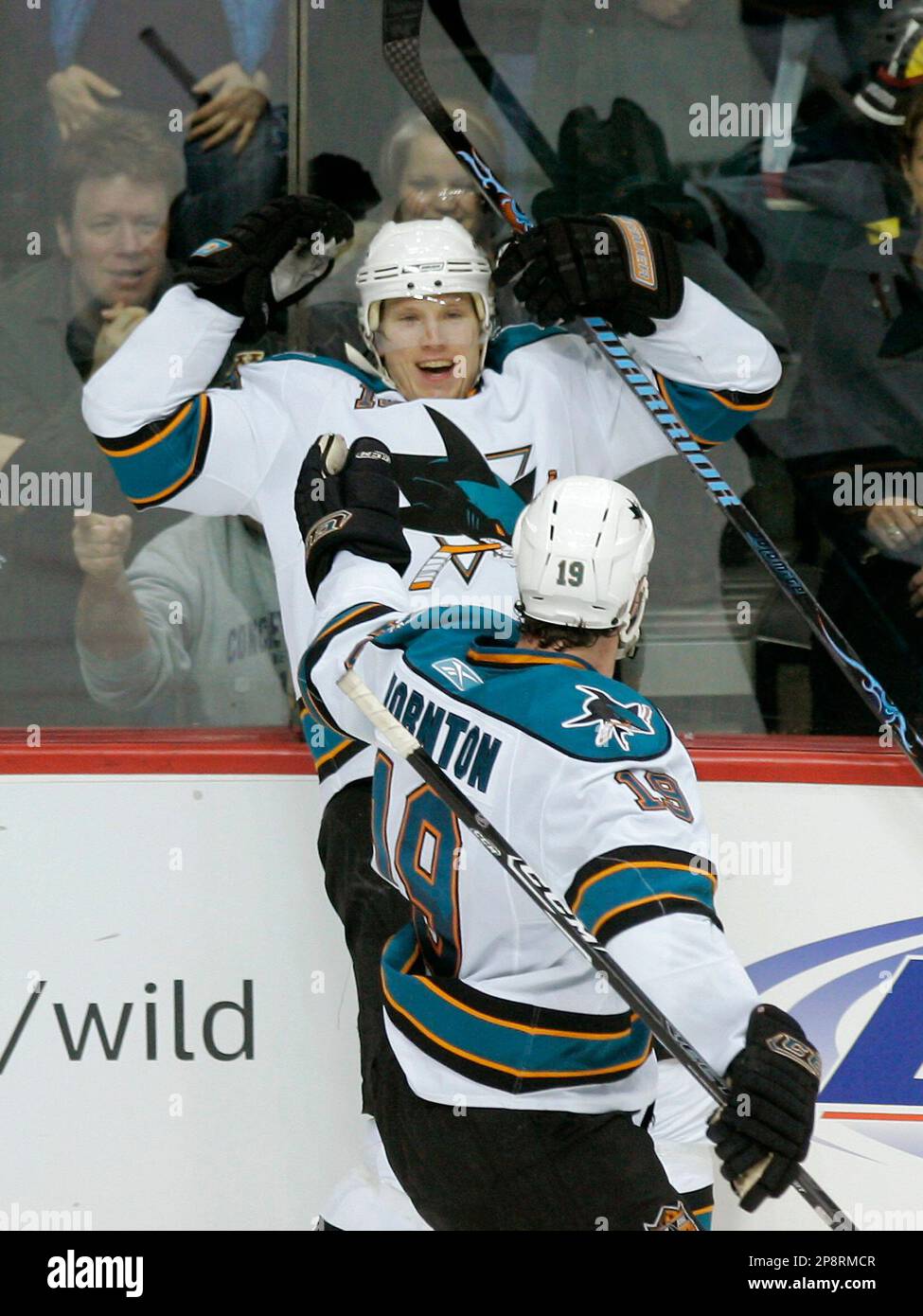 San Jose Sharks' Christian Ehrhoff, left, of Germany, celebrates his ...