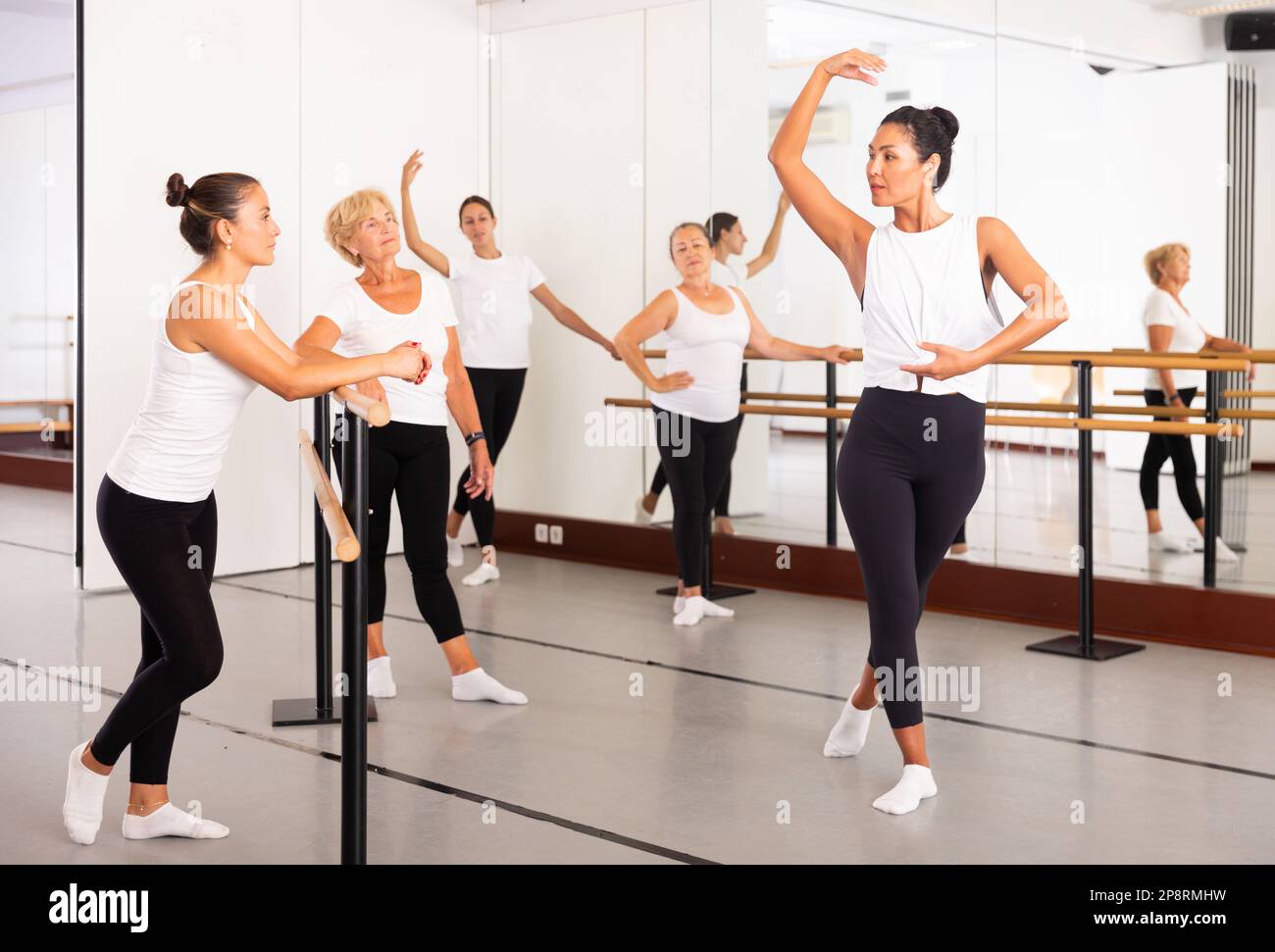 Ballet trainer showing dance moves to her students Stock Photo - Alamy