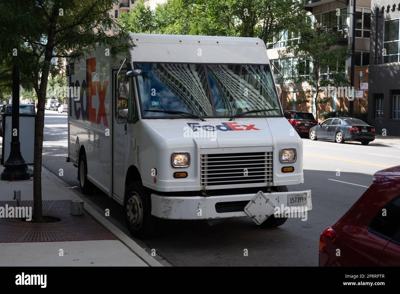 A white fedex van parked on the side of a road Stock Photo - Alamy