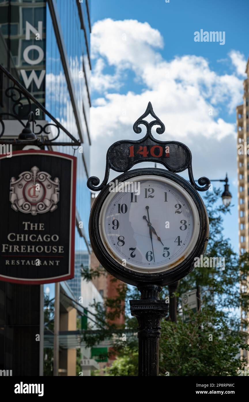 An outdoor clock displayed outside in front of the Chicago Firehouse ...