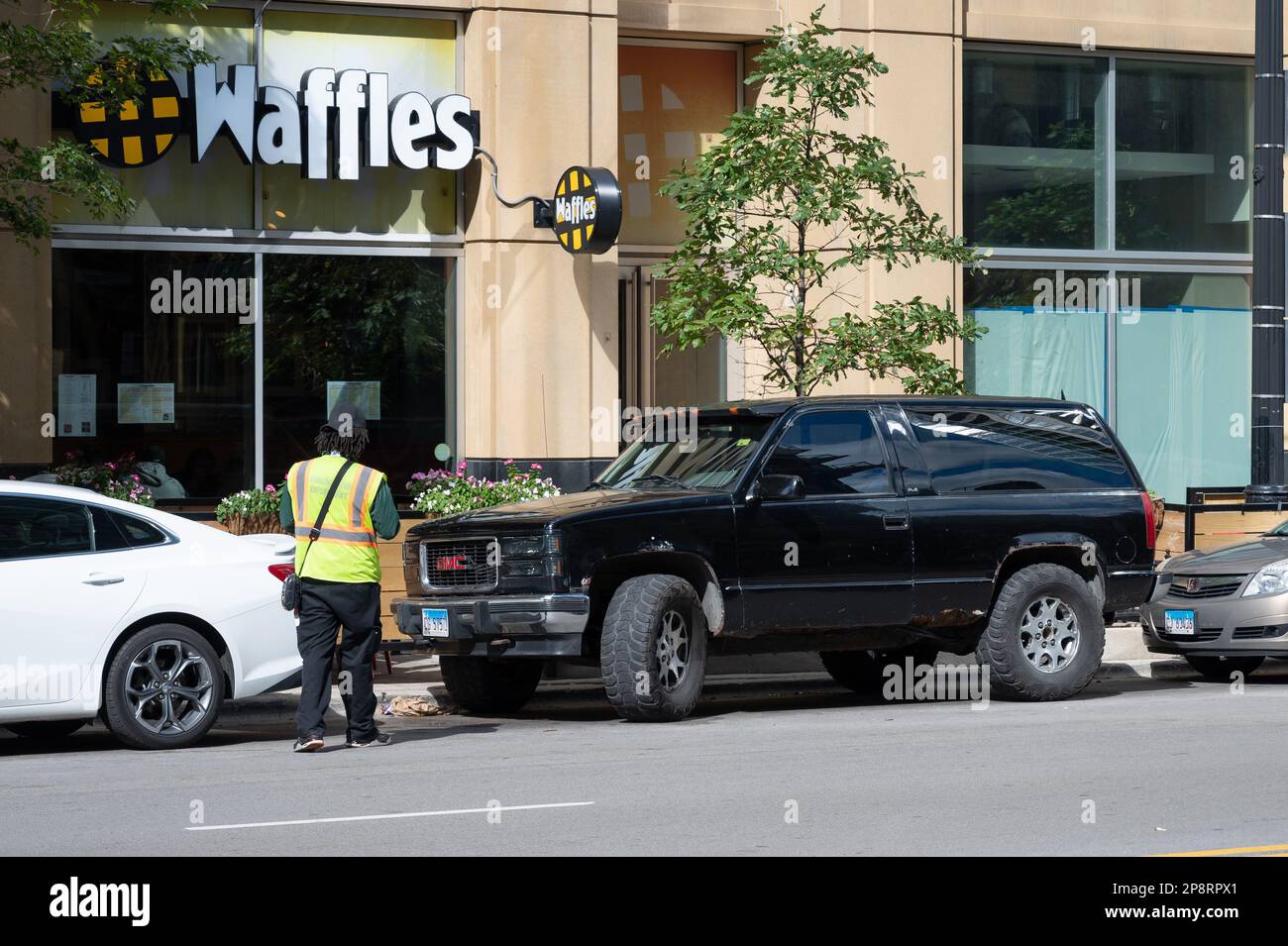 The cars parked on the road near a Waffles store Stock Photo - Alamy