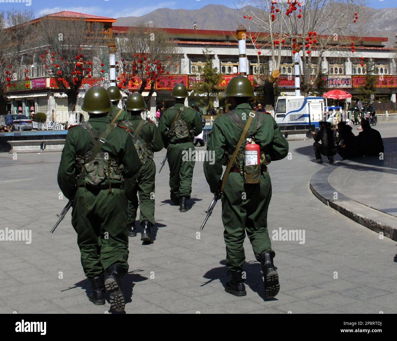 Chinese paramilitary police patrol in a street of Lhasa, the capital of ...