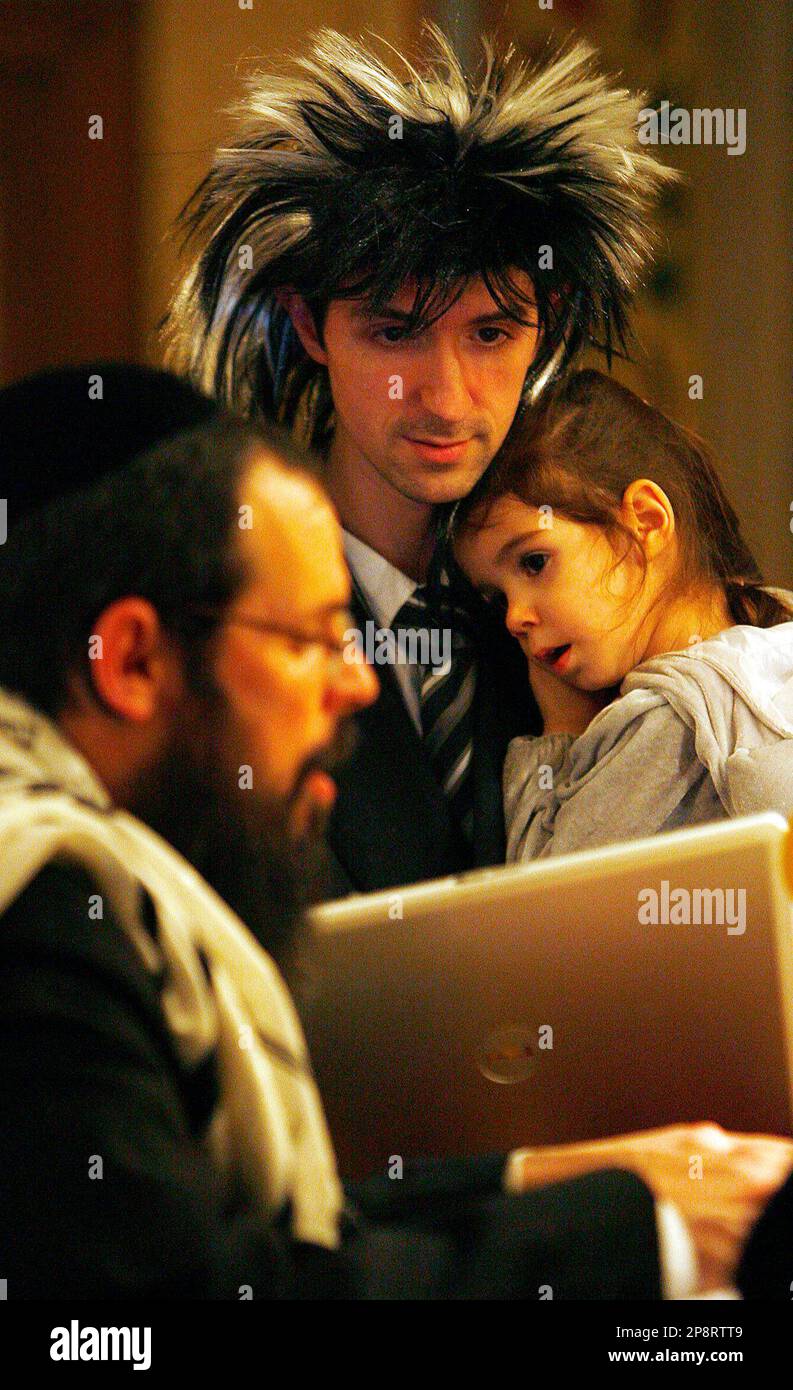 Rabbi Shlomo Sorin Rosen, center, wears a wig as he holds his daughter ...