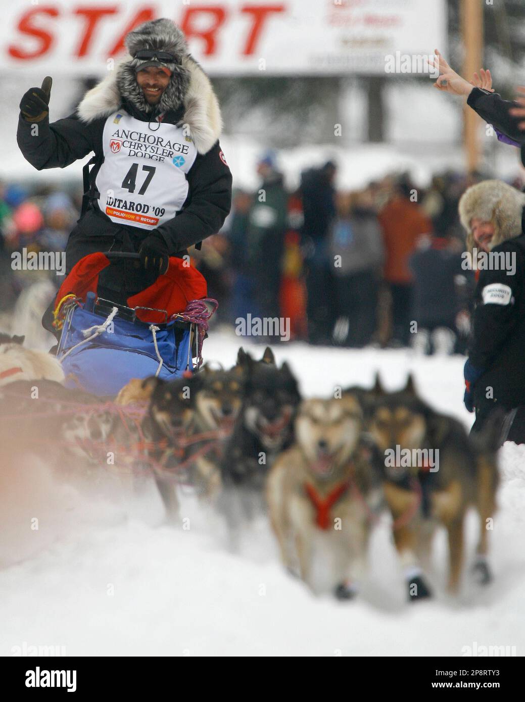 Defending Iditarod champion Lance Mackey drives his team down the ...
