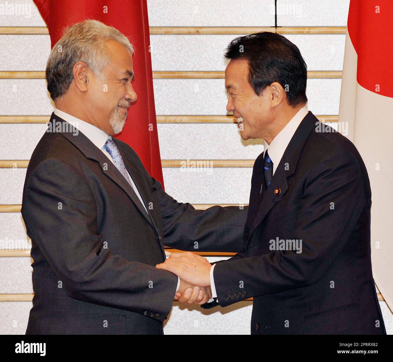 East Timor's Prime Minister Xanana Gusmao, left, is welcomed by his ...