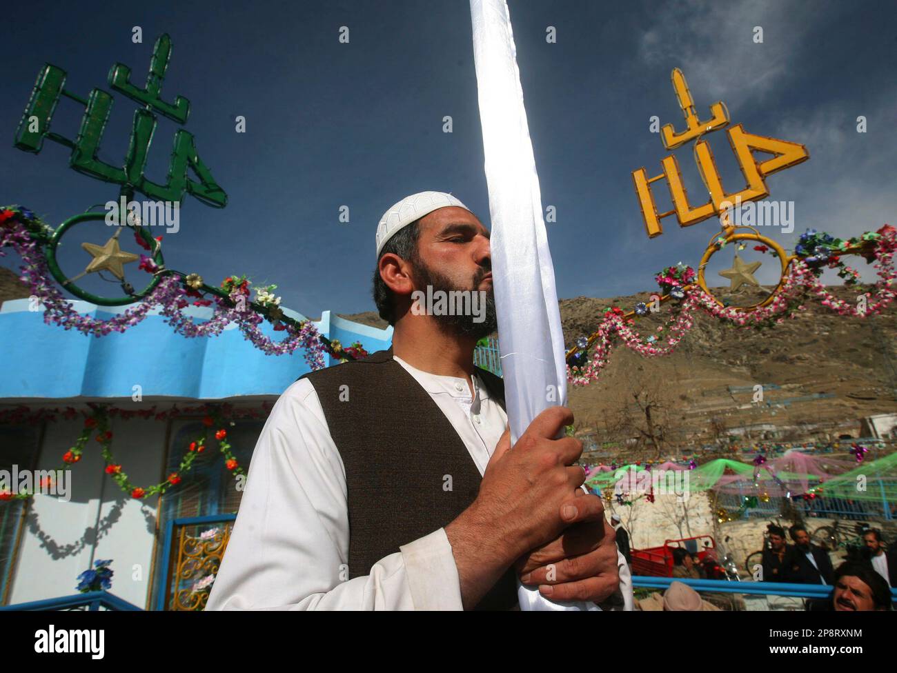 An Afghan man kisses the holy mace after offering special prayer on the ...