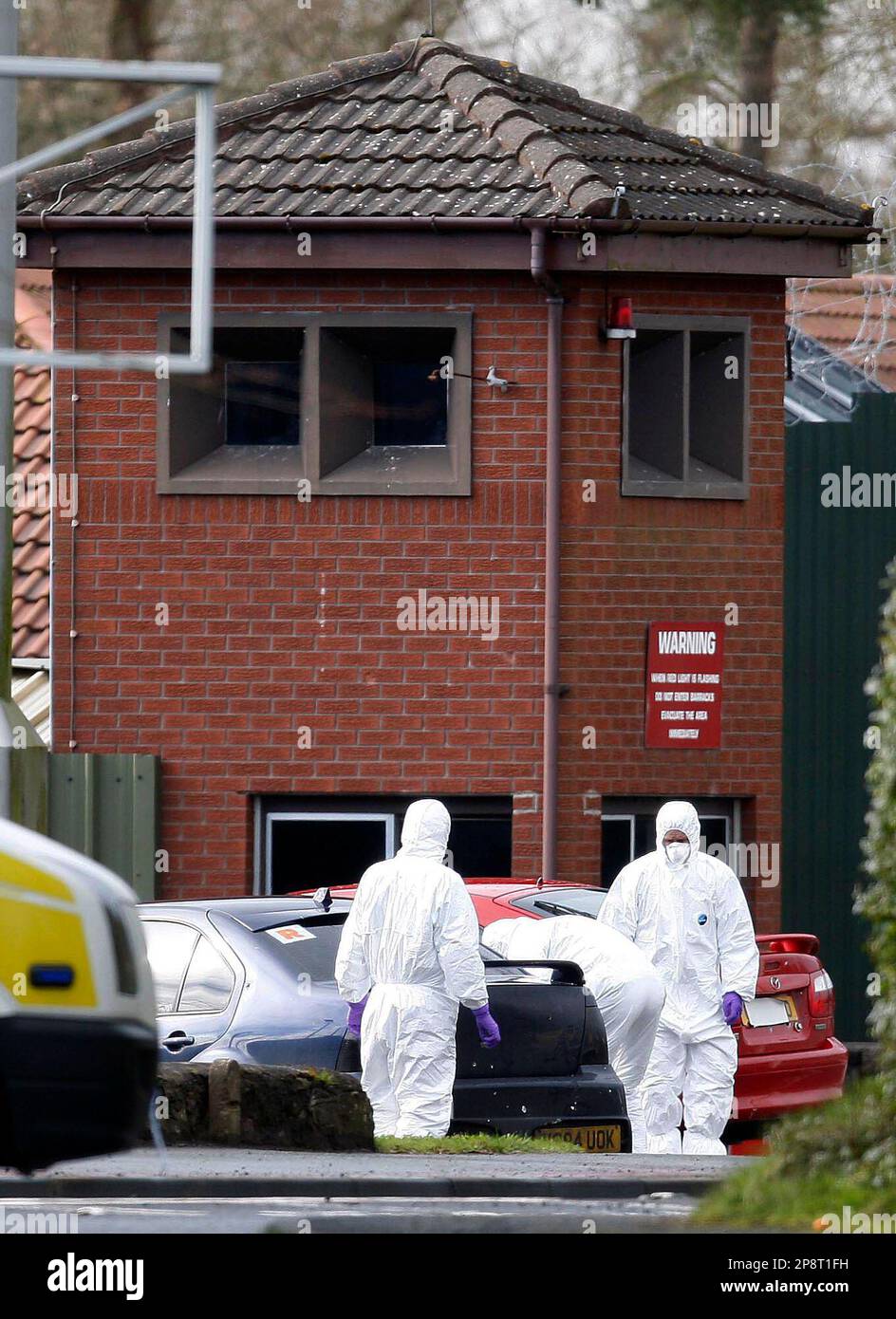 Police Forensic officers examine the scene at the Massereene army ...