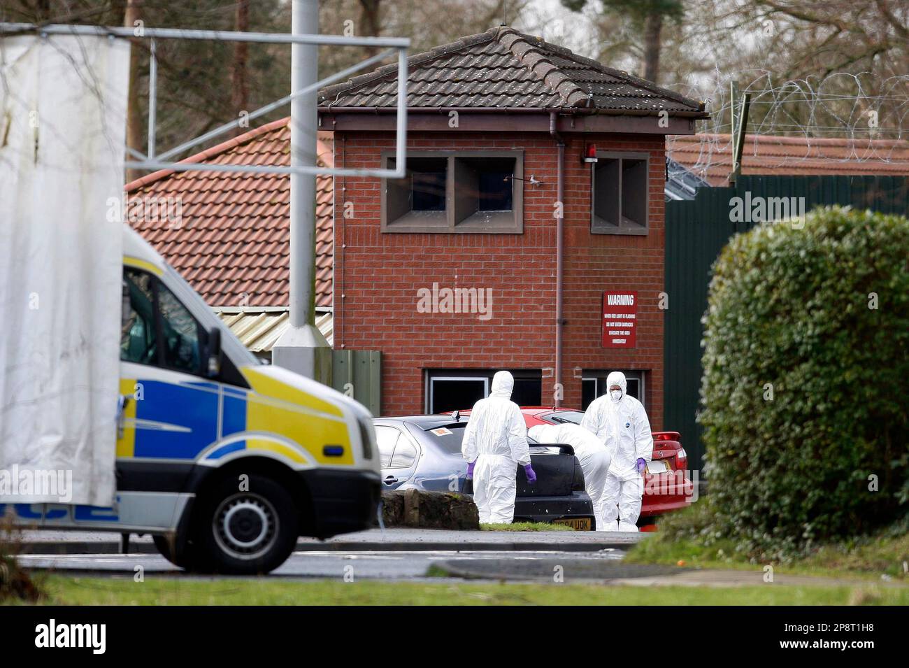 Police Forensic officers examine the scene at the Massereene army ...