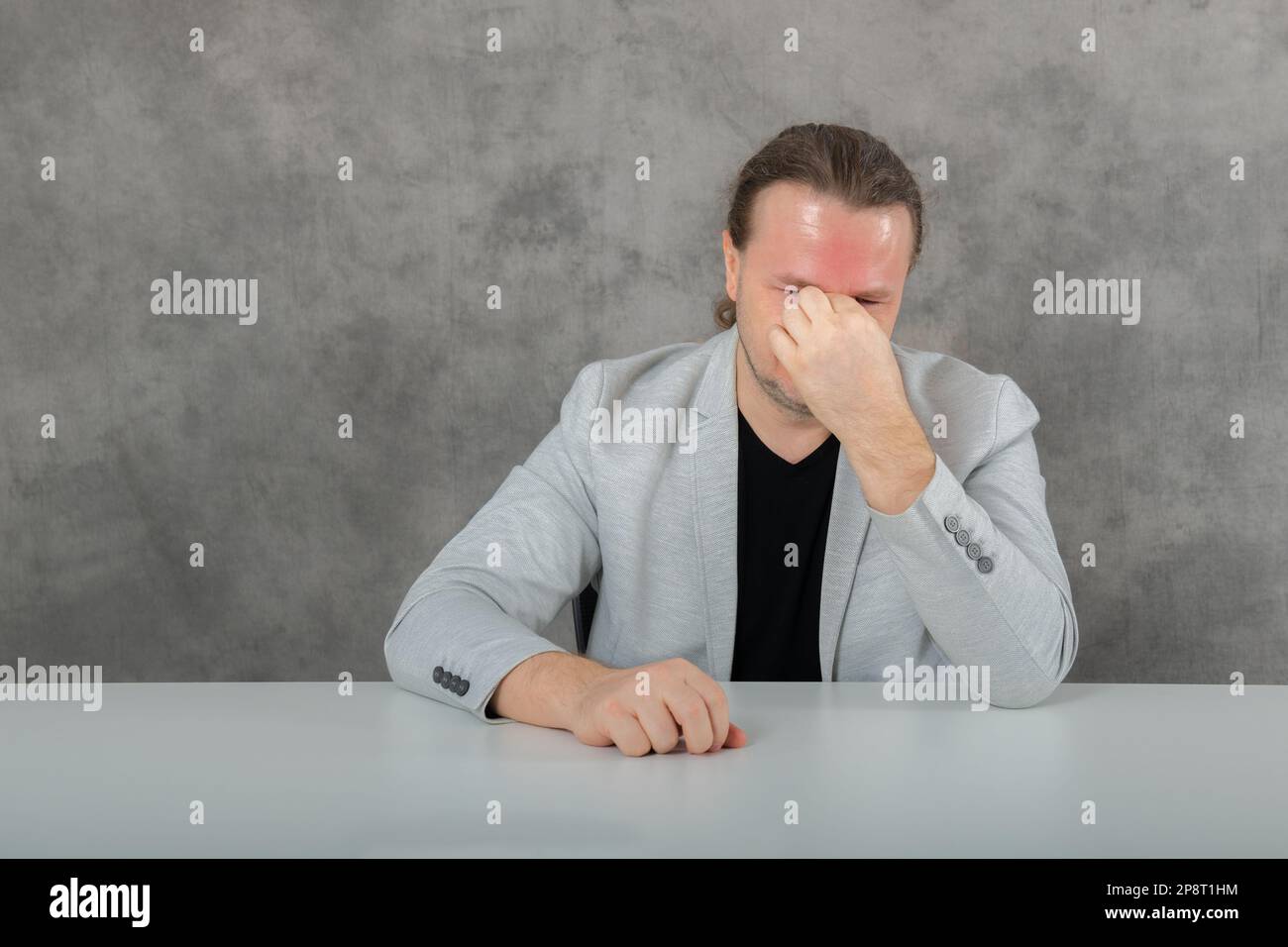 sadly covers his face with his hand one man in a gray suit Stock Photo ...