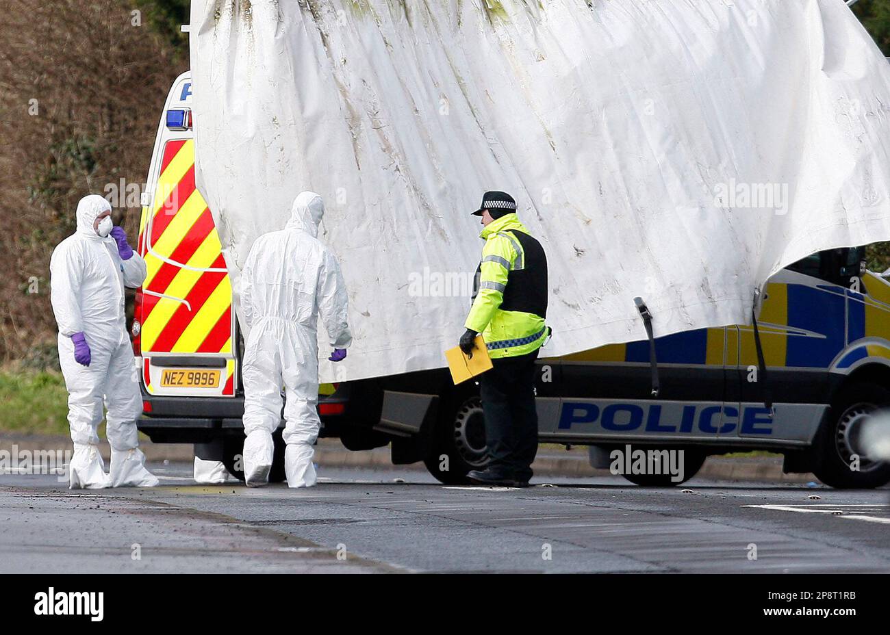 Police forensic officers examine the scene at the Massereene army ...