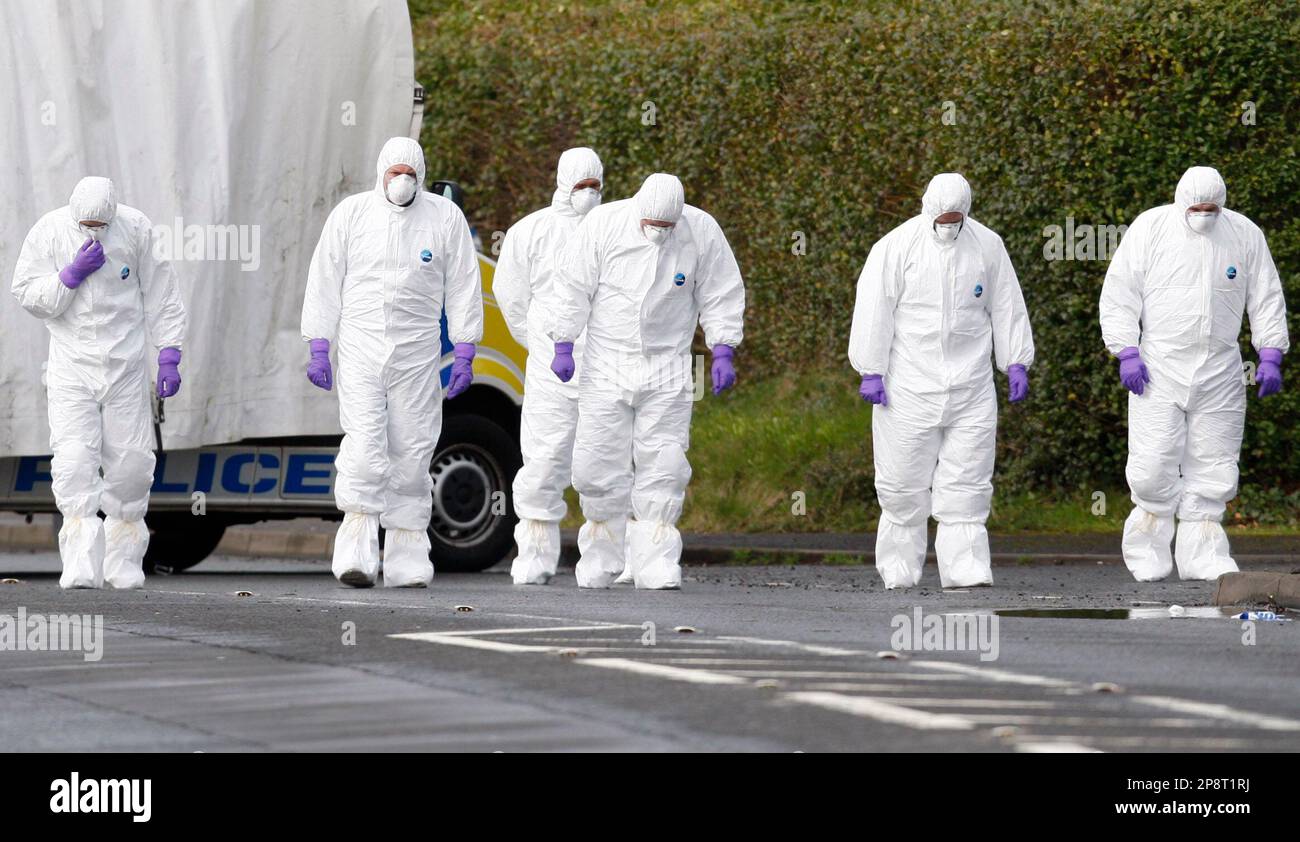 Police forensic officers examine the scene at the Massereene army ...