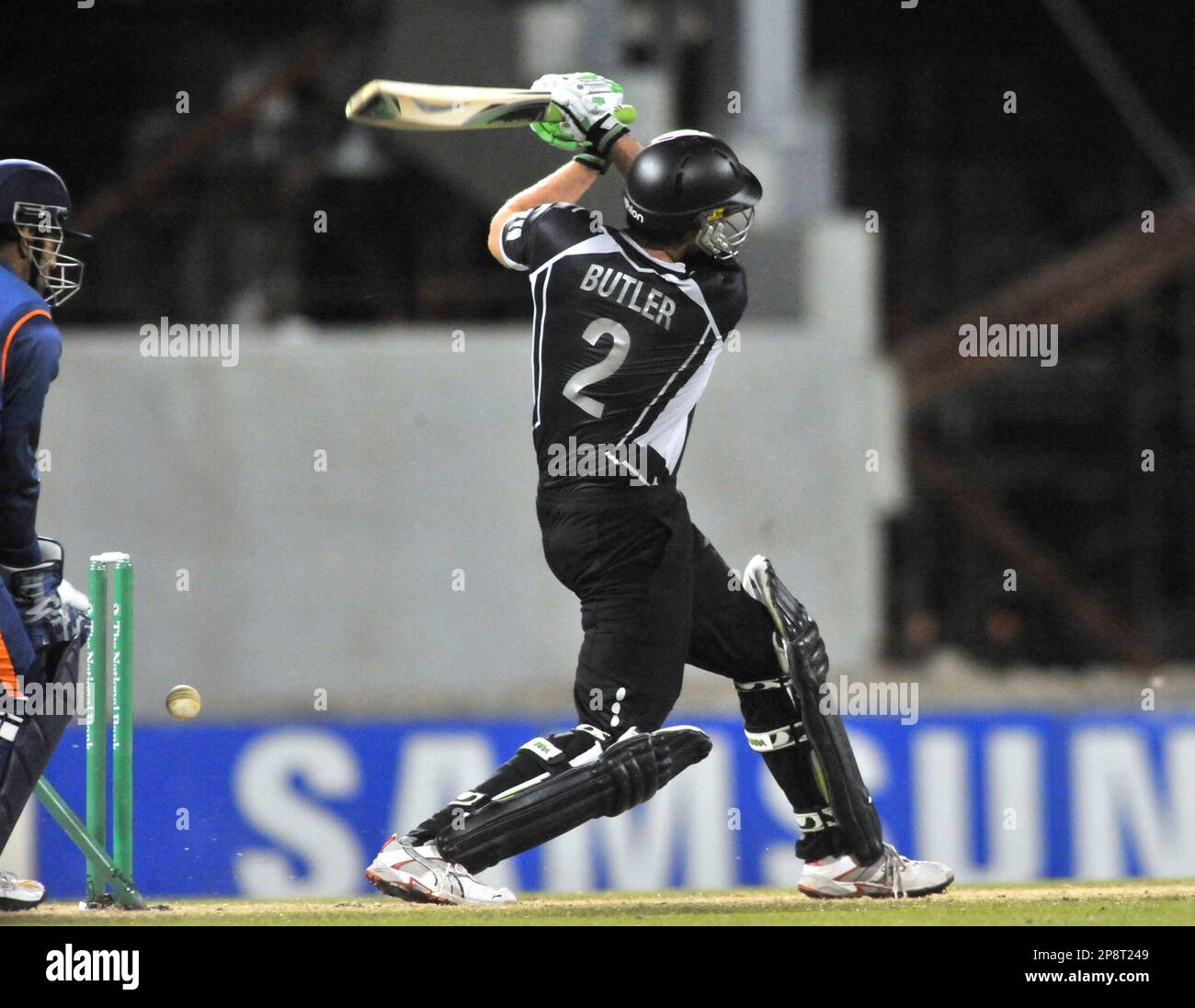 New Zealand's Ian Butler is bowled in front of Indian wicket keeper M.S ...