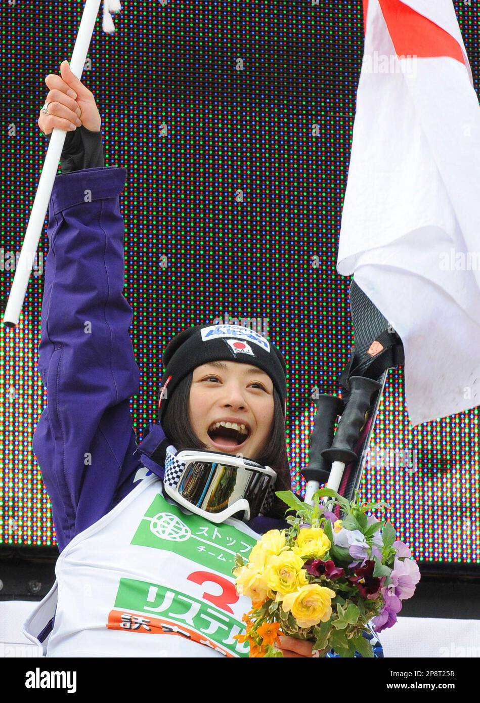 Japan's Aiko Uemura waves a national flag on the podium after winning ...