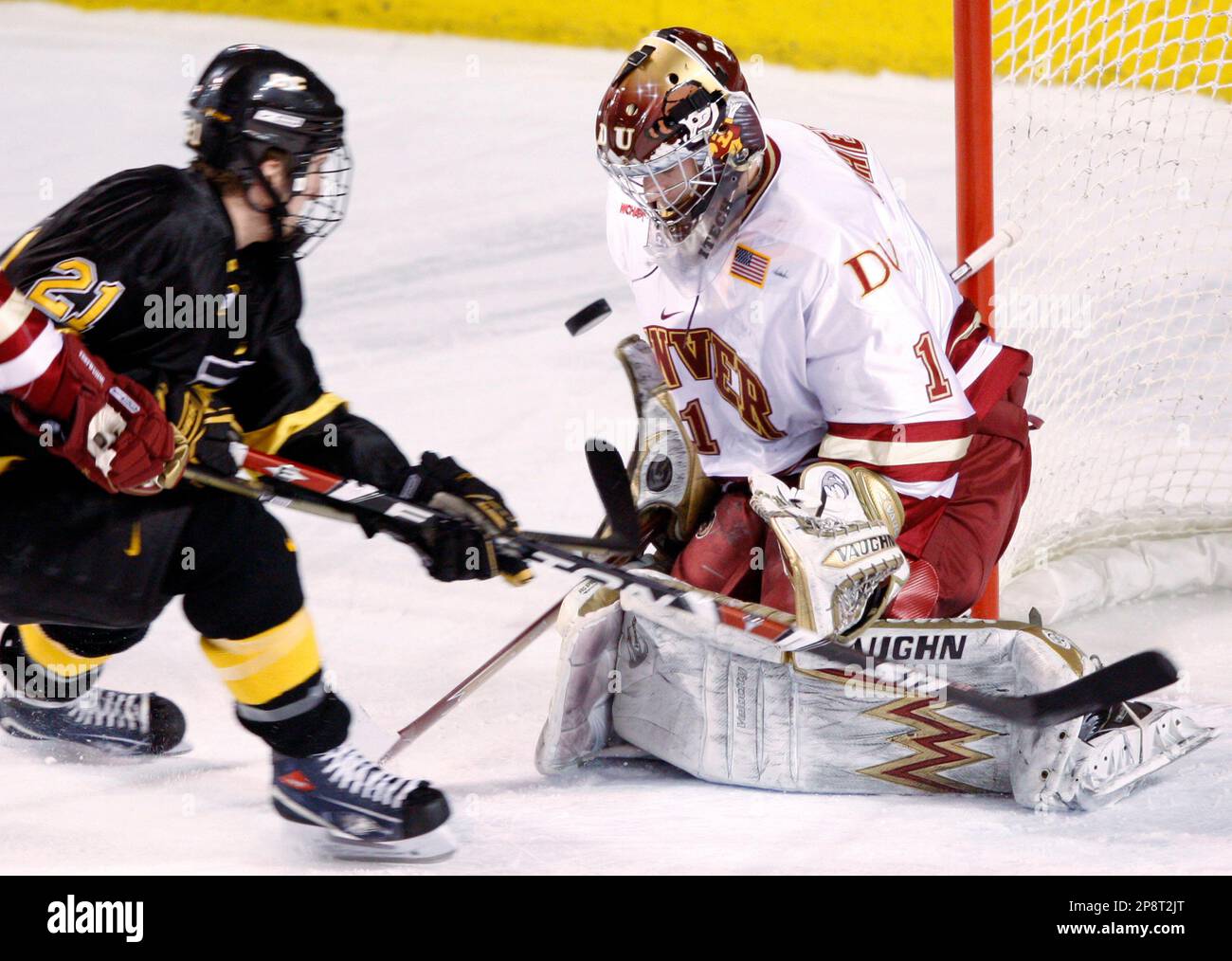 Denver goaltender Marc Cheverie (1) blocks a shot by Colorado College ...