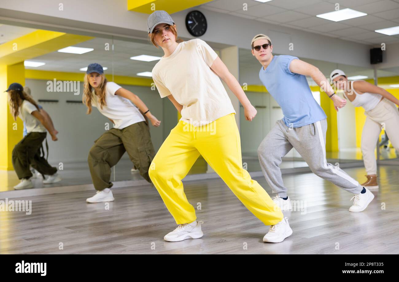 Expressive sporty young people tilting their bodies and lunging in ...