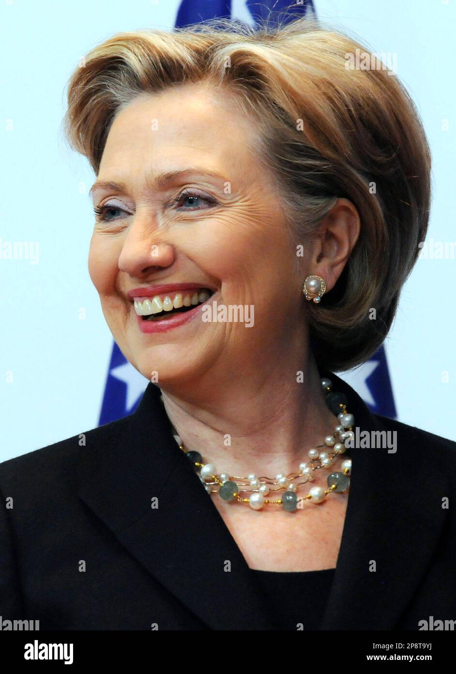 U.S. Secretary of State Hillary Rodham Clinton smiles as she arrives ...