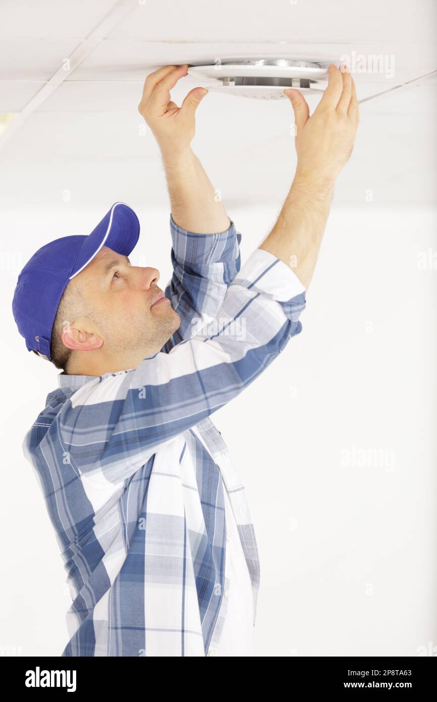 electrician fitting a ventilation system Stock Photo - Alamy