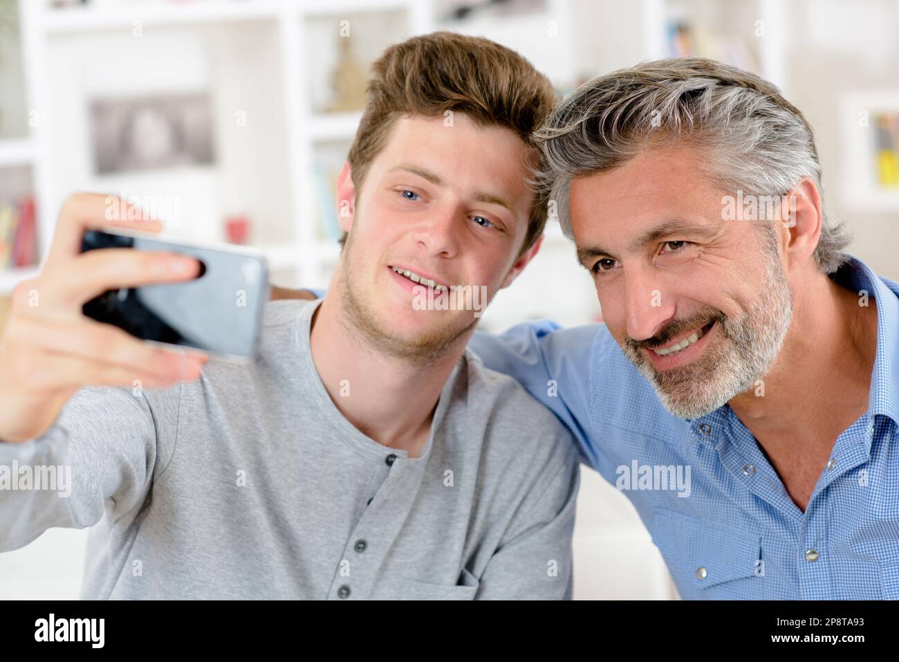 son and father during smartphone conversation Stock Photo - Alamy