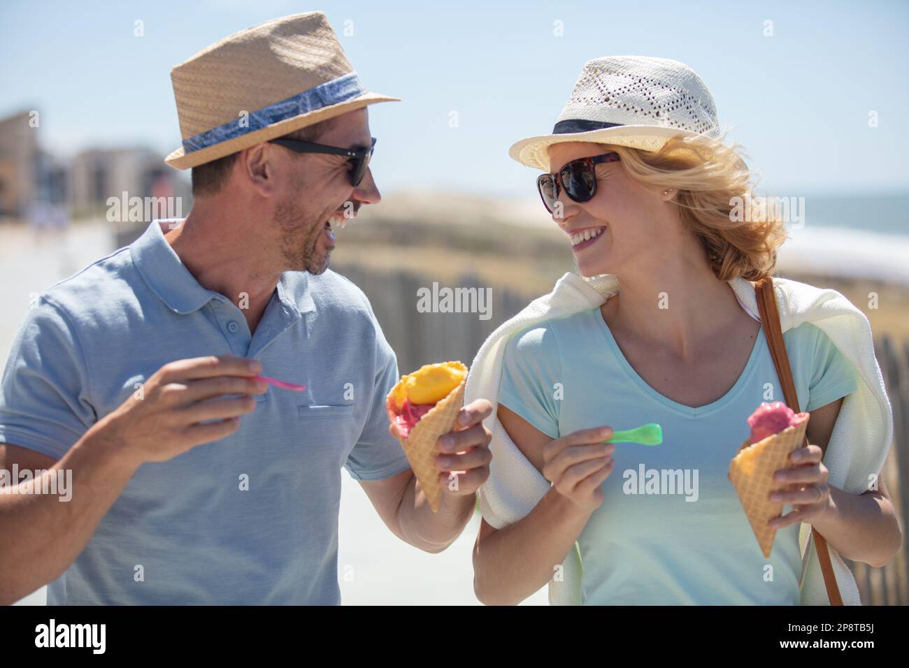 happy couple eating ice cream at the beach Stock Photo - Alamy