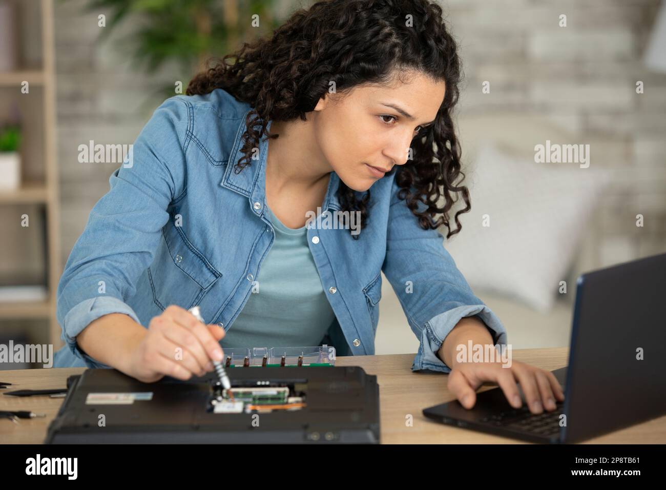 Repairing electronics woman hi-res stock photography and images - Alamy