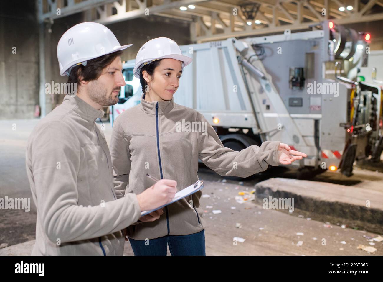 municipal workers talking with refuse lorry in background Stock Photo ...