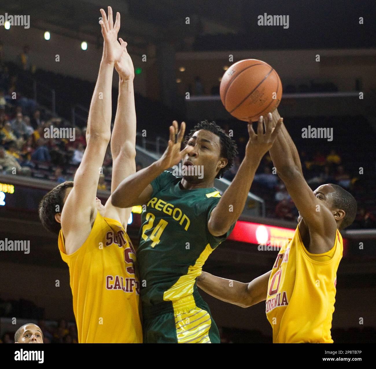 Oregon's Lekendric Longmire (24) fights for the ball against USC ...