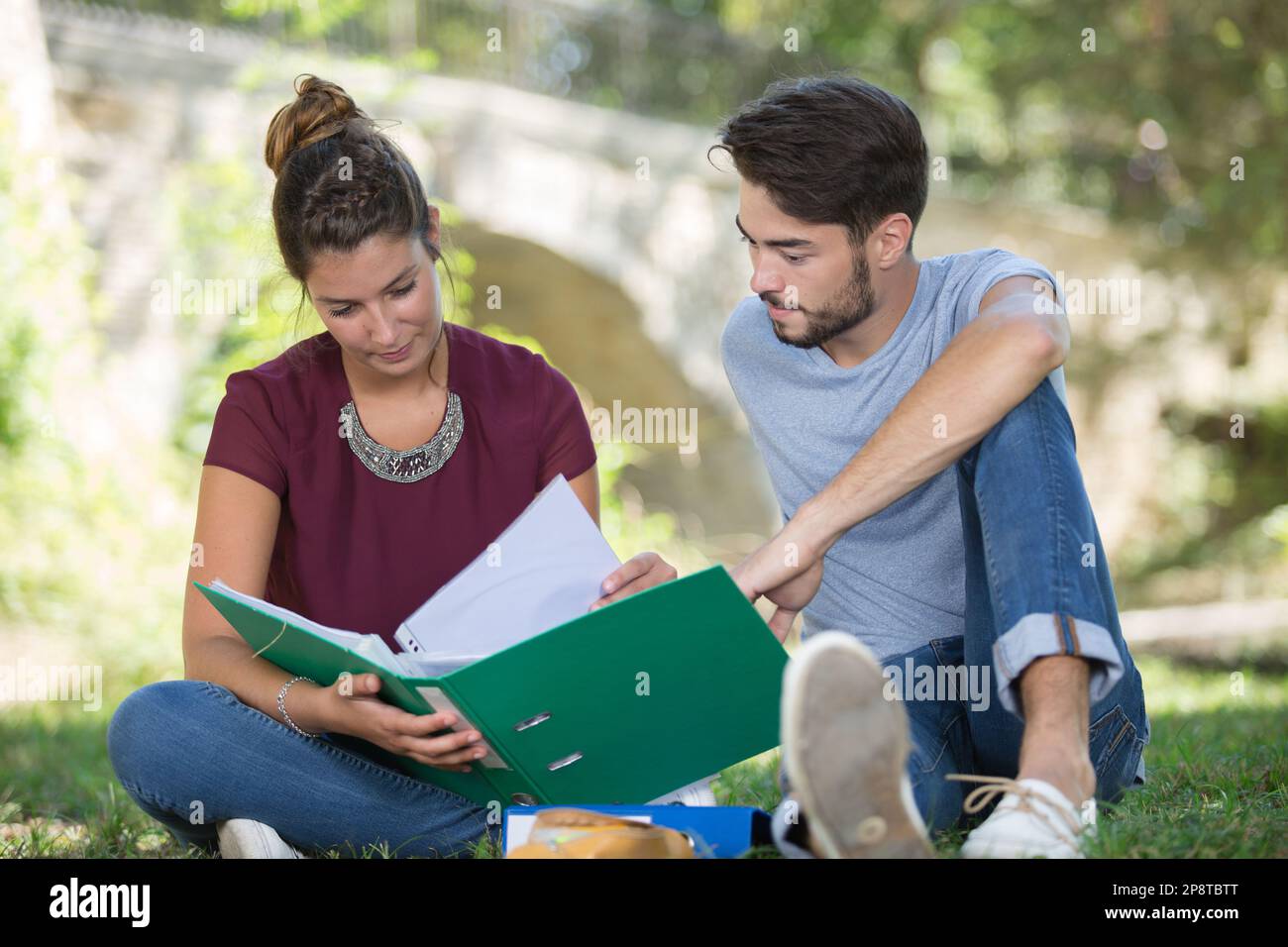 two smiling students studying outdoor Stock Photo - Alamy