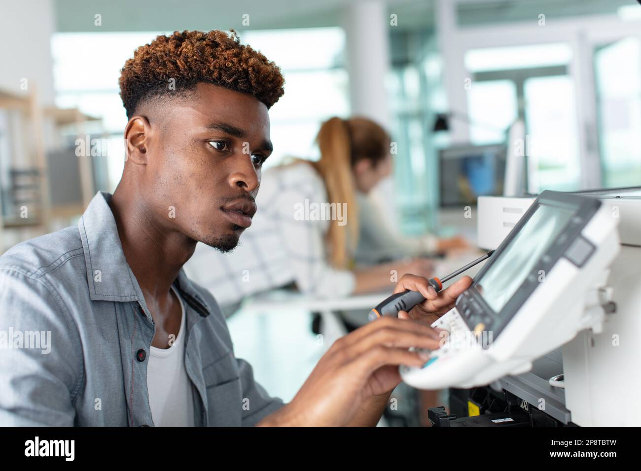 repairing a printer at work Stock Photo - Alamy