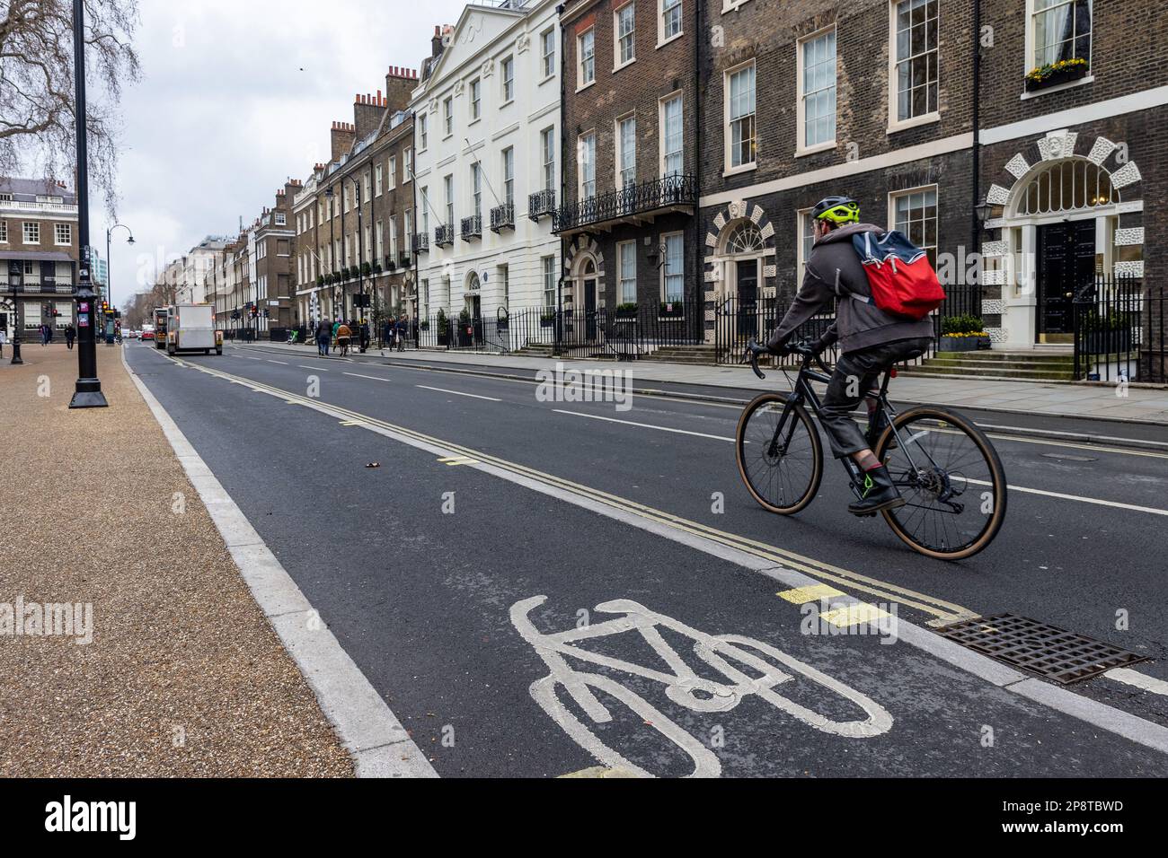 London, UK. 7th March, 2023. A cyclist passes alongside a cycle lane ...