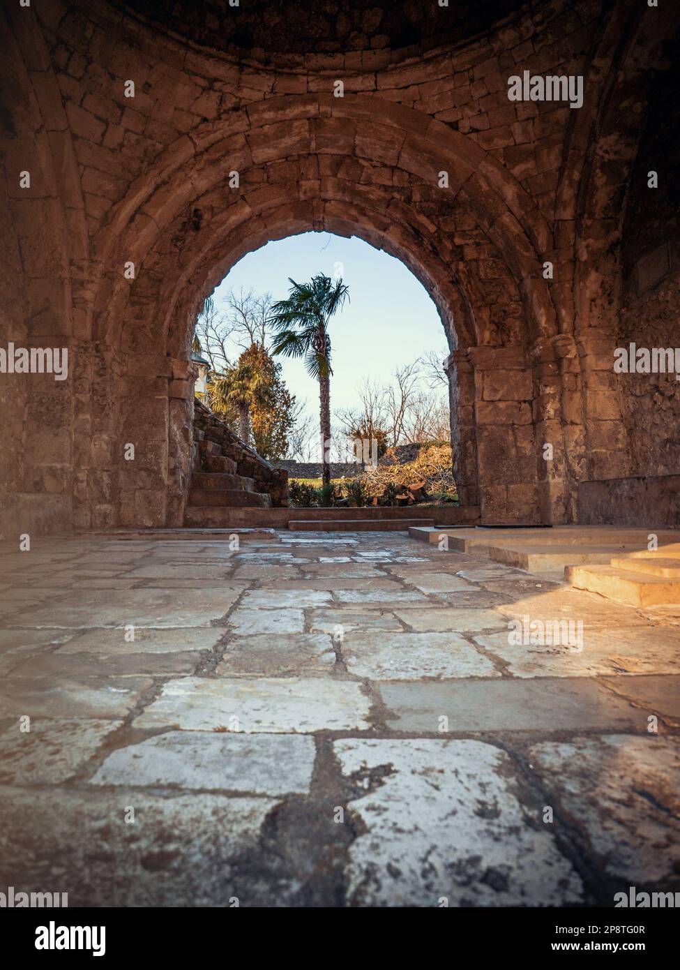 Ancient religious building made of stone with an arched passage in ...