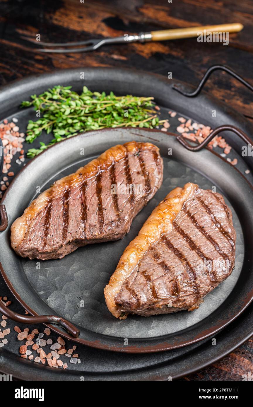 BBQ Grilled top sirloin steak, cup rump beef meat steak in a steel tray ...
