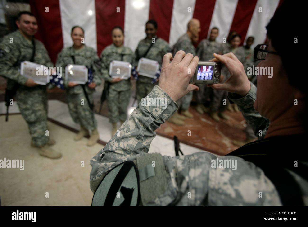 U.S. Army soldiers pose for a photo after their naturalization ceremony ...