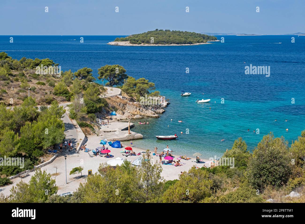 Tourist swimming and sunbathing on tiny beach along the Adriatic Sea ...