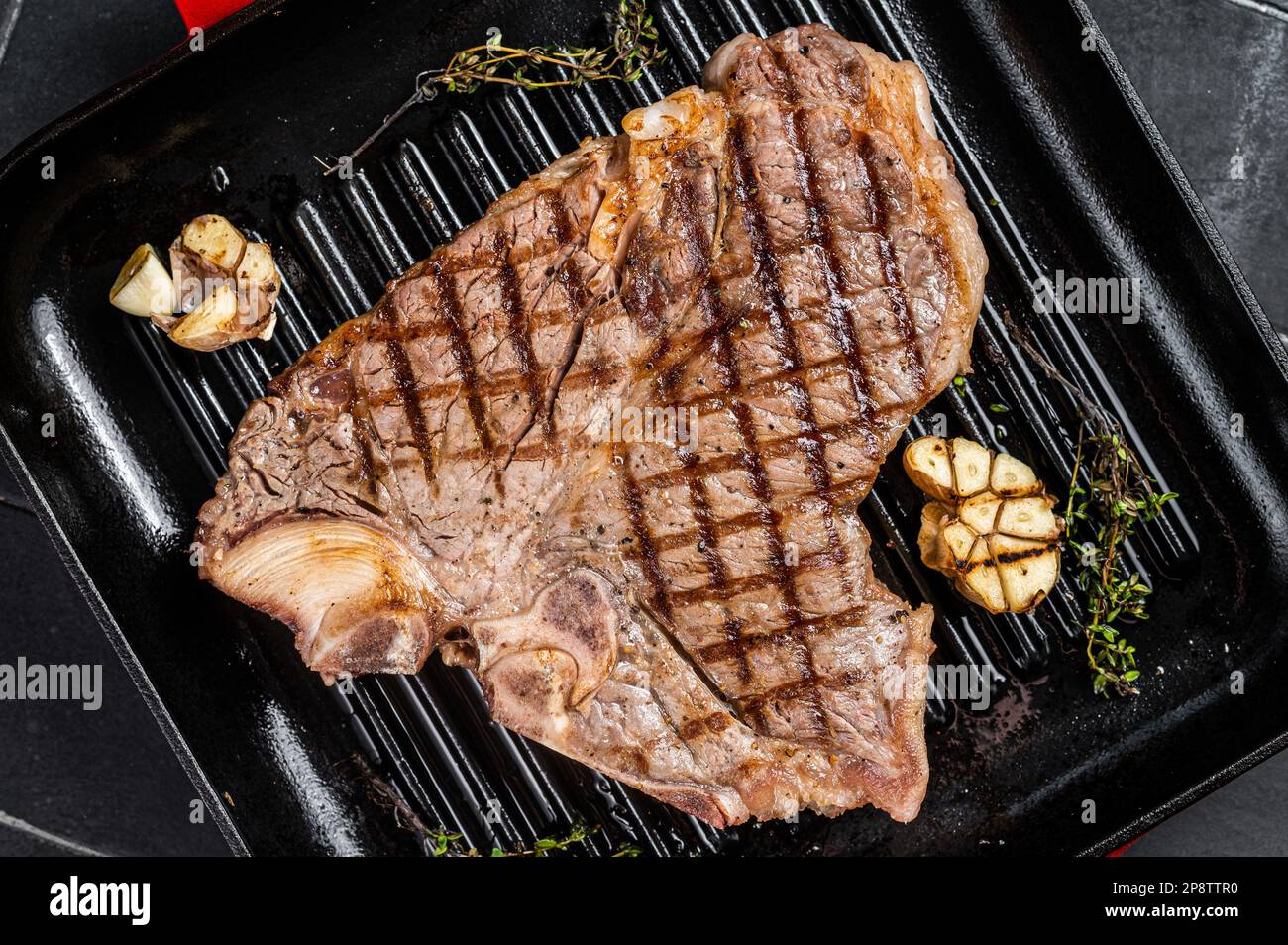 Grilled T-bone, t bone beef meat Steak on a grill skillet. Black ...